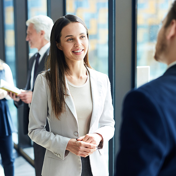 Co-workers talking and collaborating in the office.