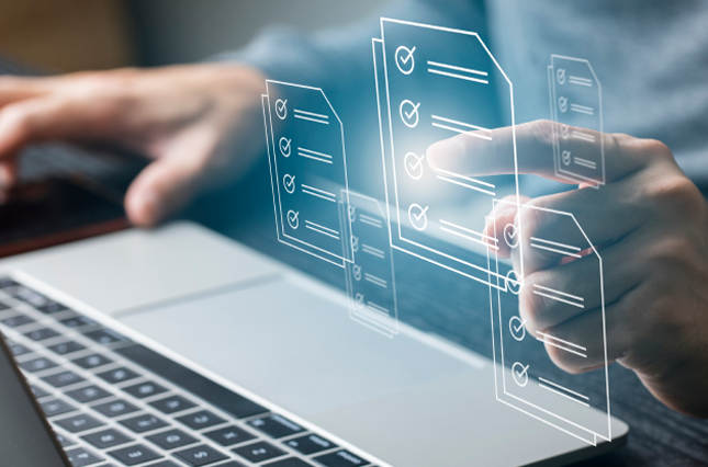 Person on laptop accessing on-demand training manuals.