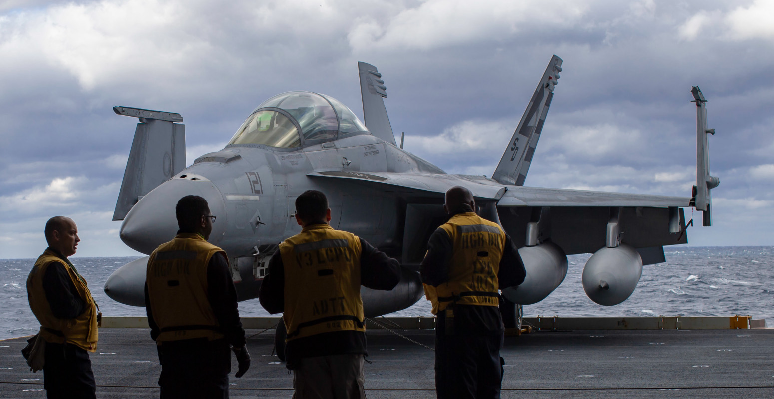 F/A-18 Aircrew standing outside aircraft.