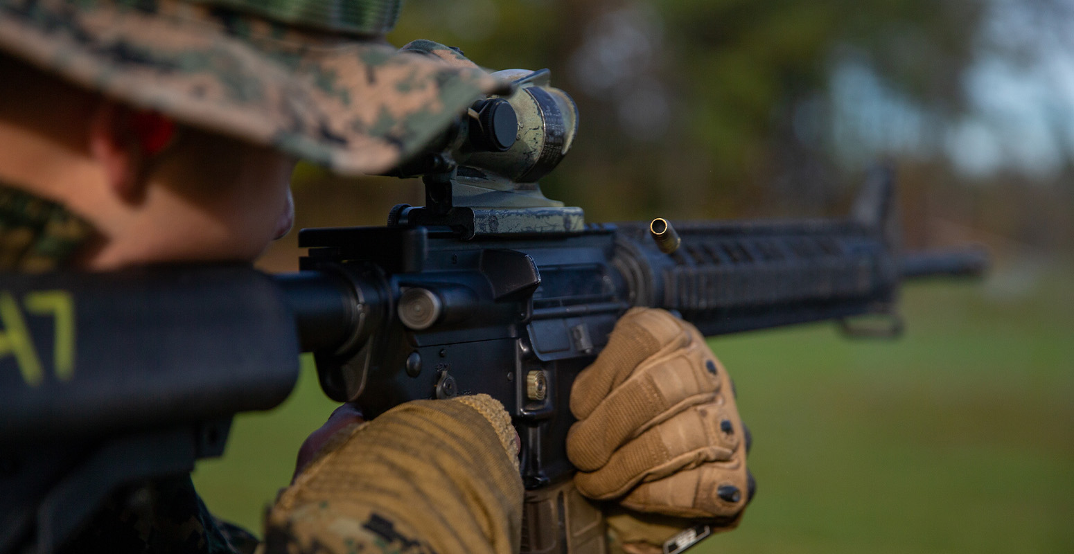 U.S. Marine Corporal training by aiming a weapon.